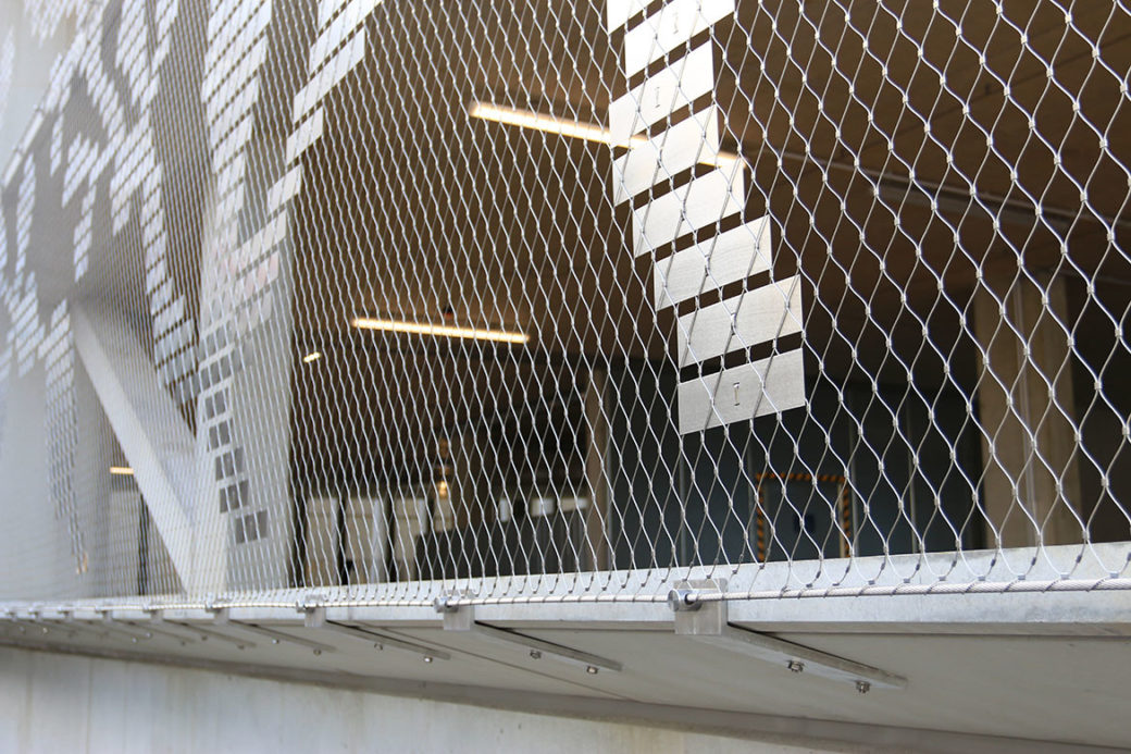 Held together by function and aesthetics: tensile mesh barriers and ...